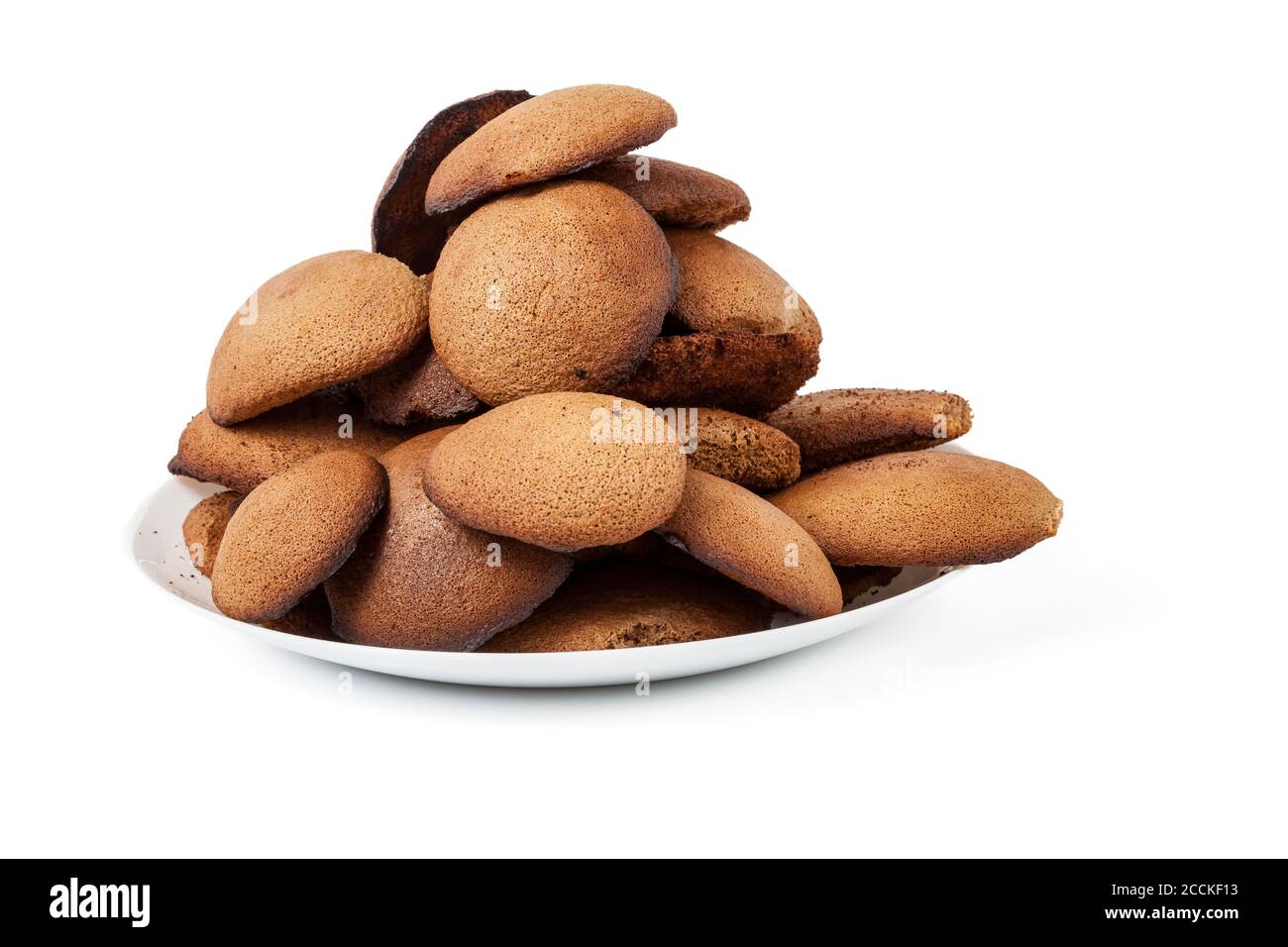 Brown homemade round shape cookies lined with a slide on a plate on a ...