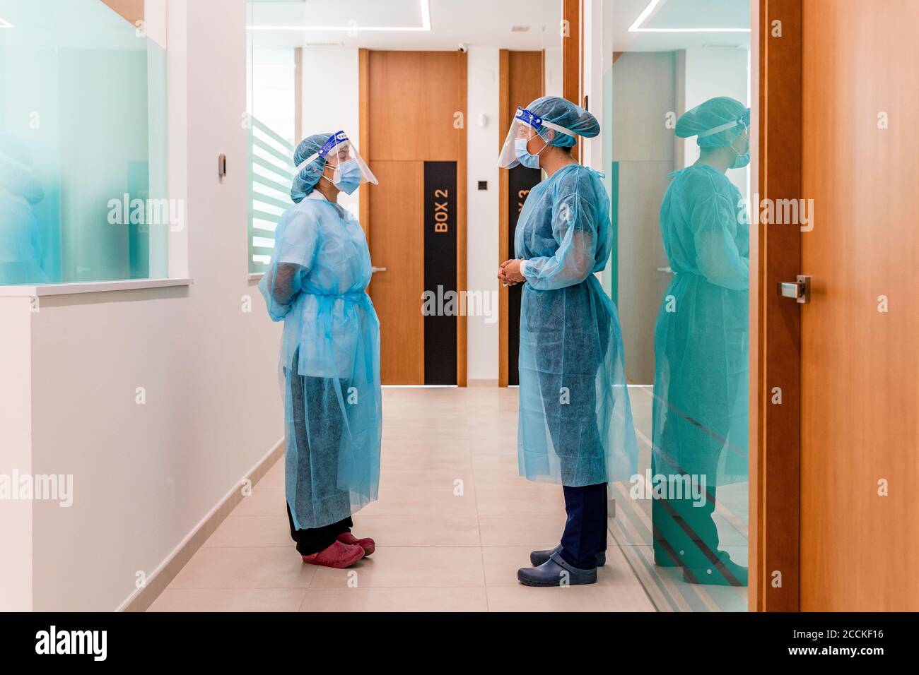 Female nurses discussing in corridor of hospital Stock Photo - Alamy