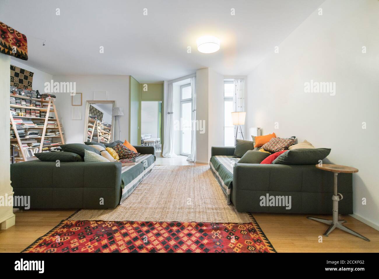 Living room with two sofas standing opposite Stock Photo - Alamy