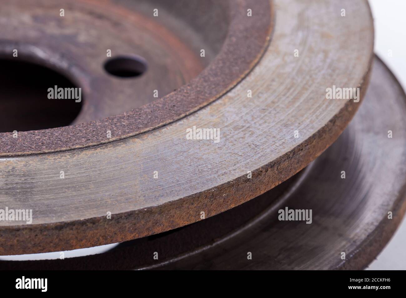 Close-up of element of old brake discs covered with rust on white ...