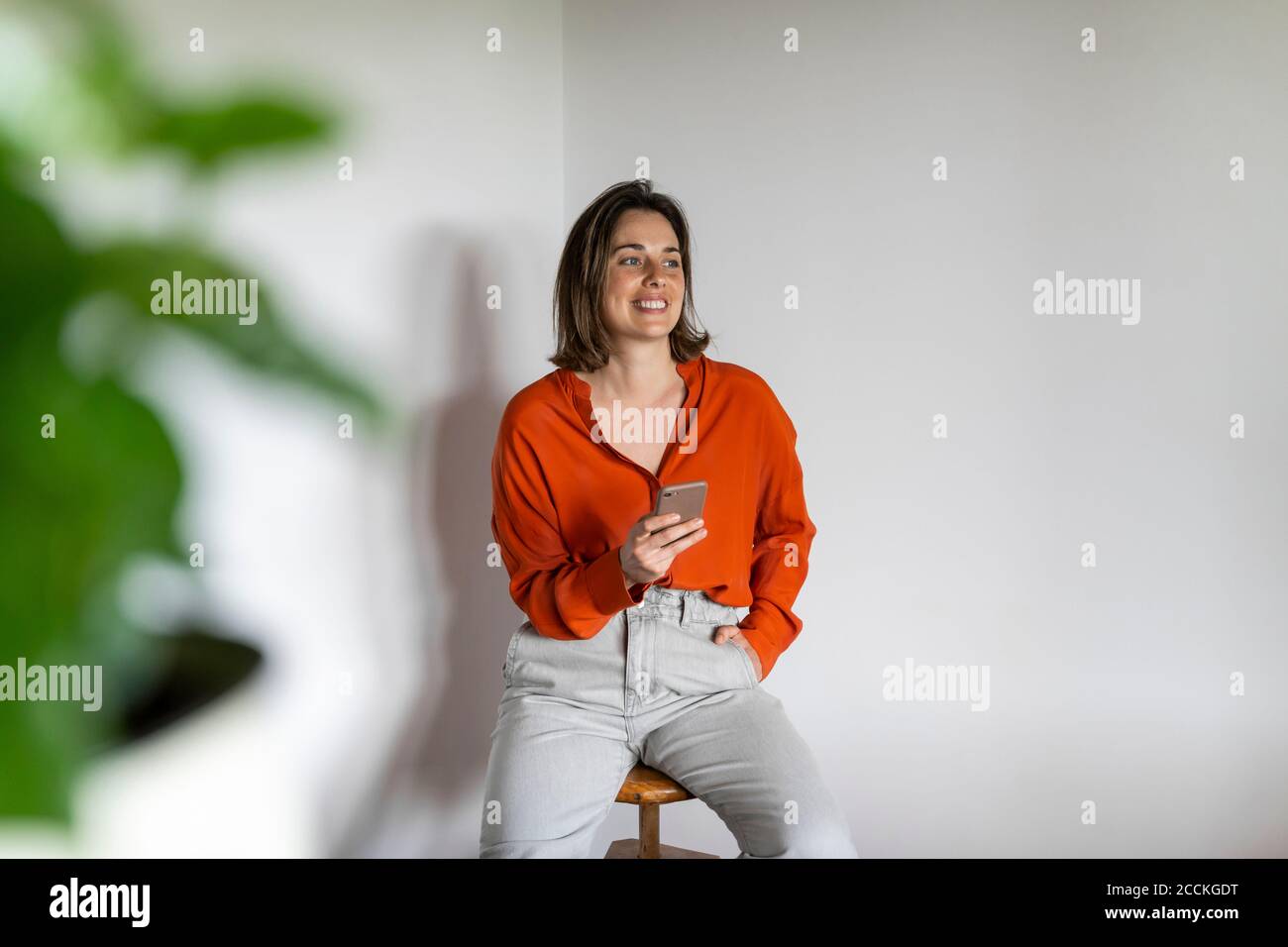 Smart woman sitting on stool hi-res stock photography and images - Alamy