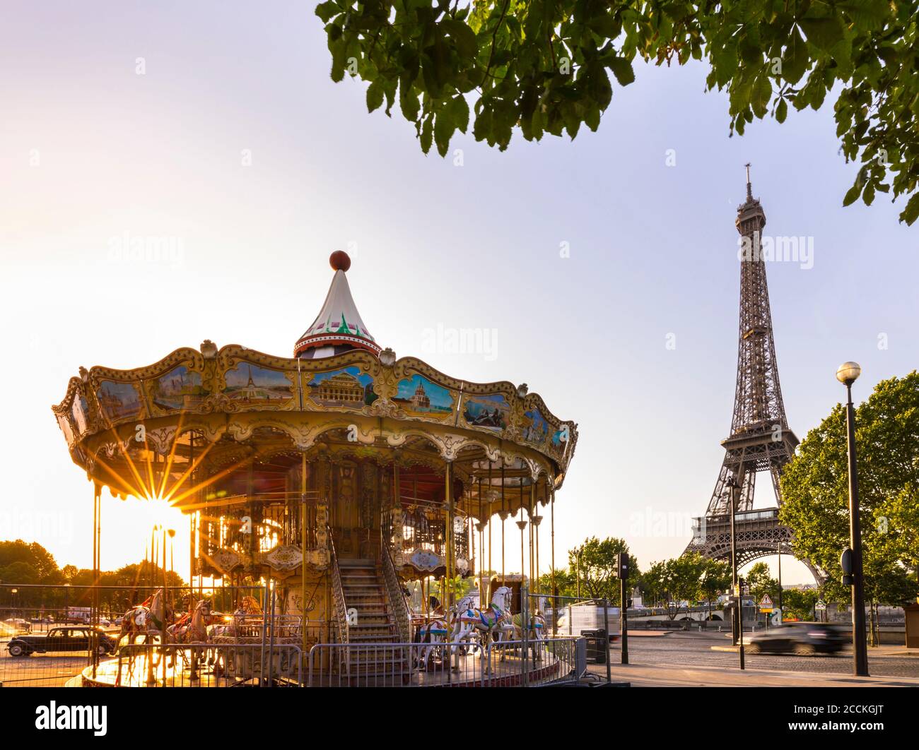 Carousel and Eiffel Tower against clear sky during sunrise, Paris ...