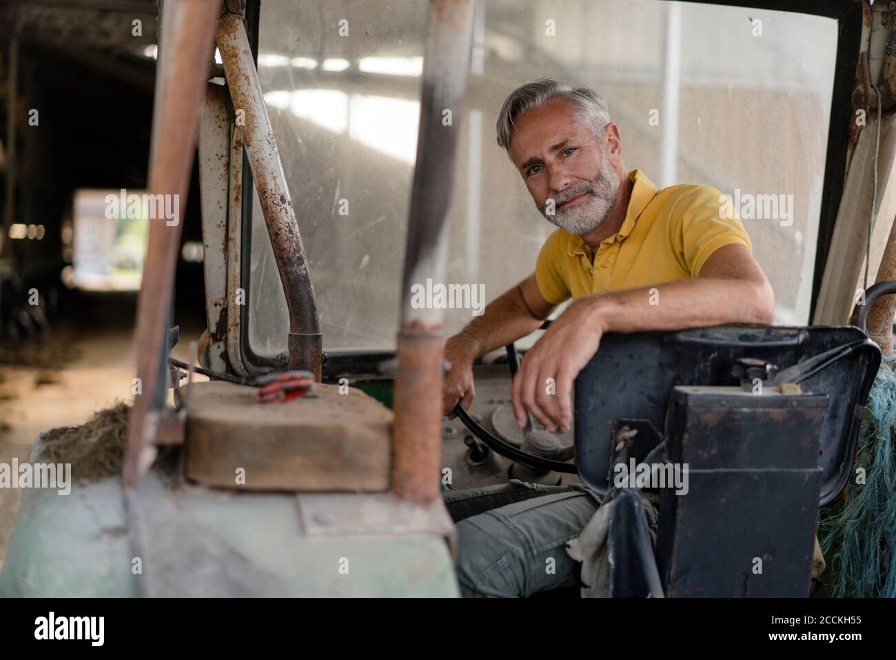 Farmer sitting on a tractor hi-res stock photography and images - Alamy