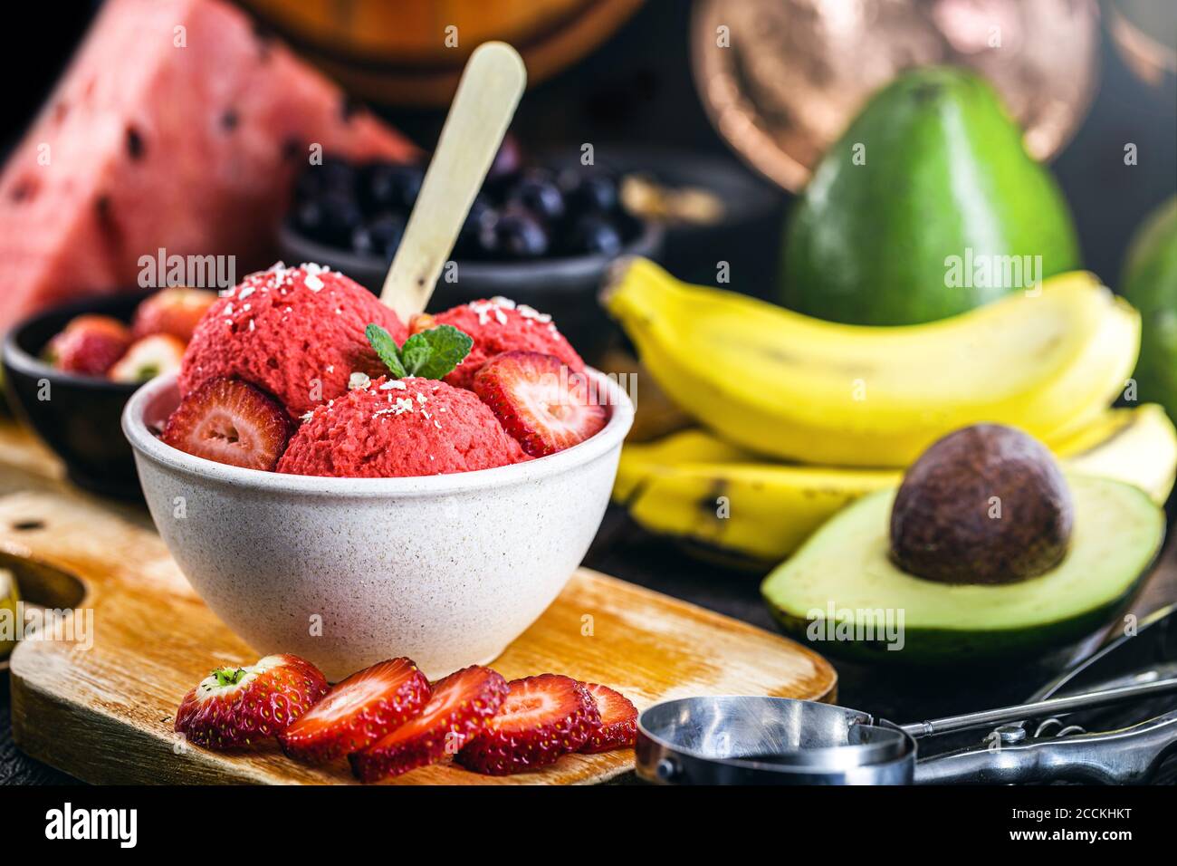 vegan strawberry ice cream with tropical fruits in the background ...