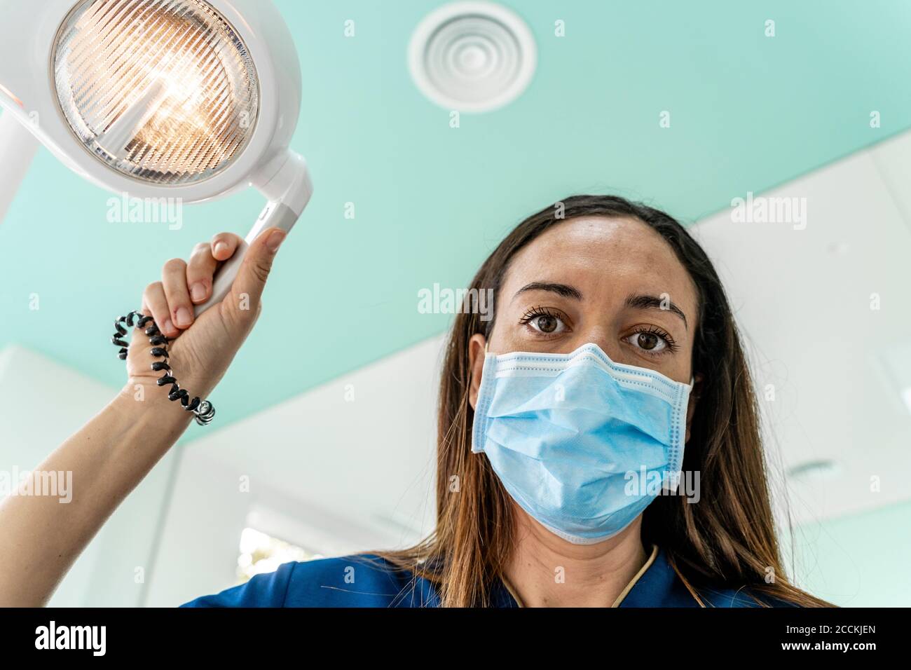 Doctor with adjustable light working in dentist's clinic Stock Photo ...