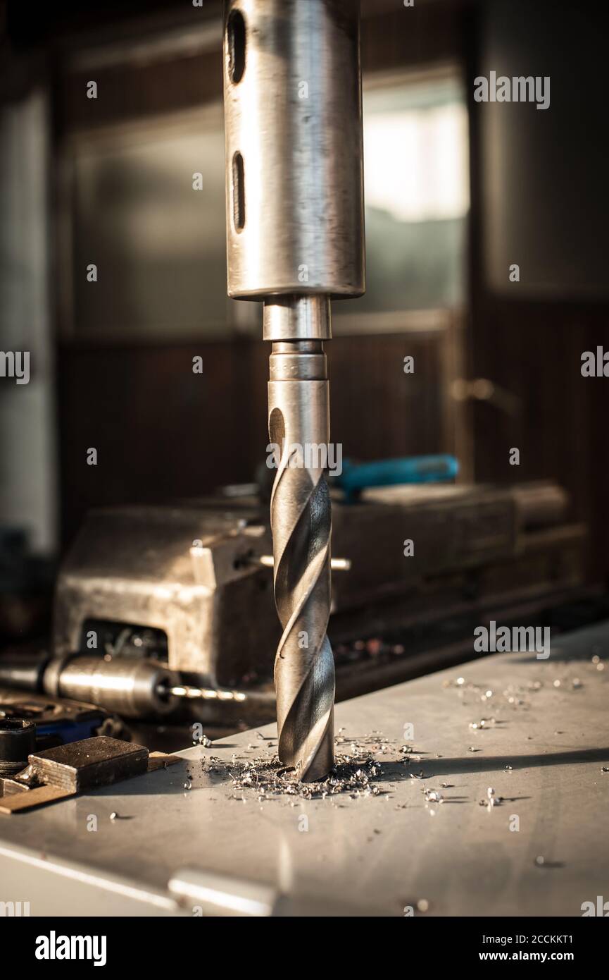 Large and powerful automatic heavy industrial drill bit cutting the ...