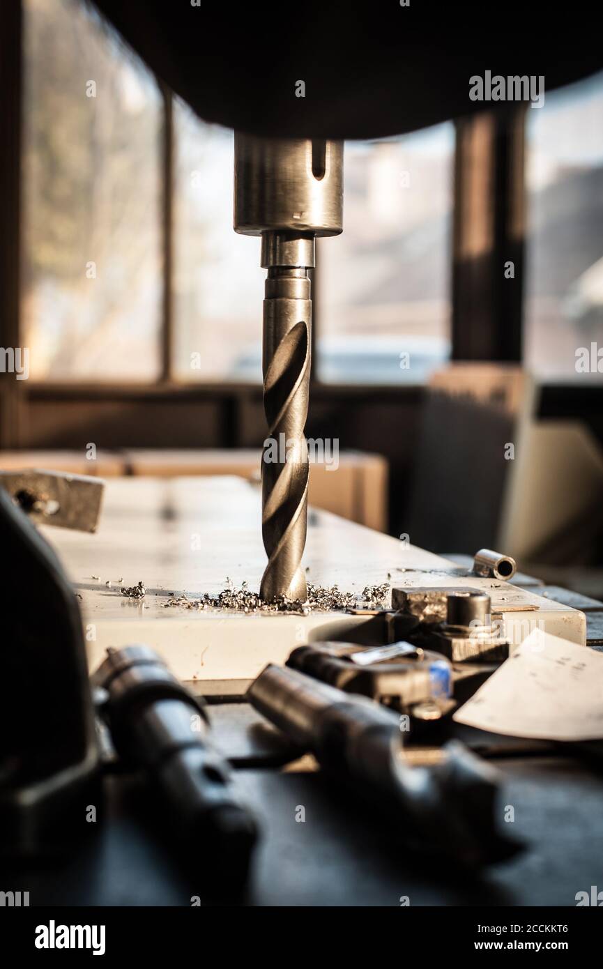 Large and powerful automatic heavy industrial drill bit cutting the ...