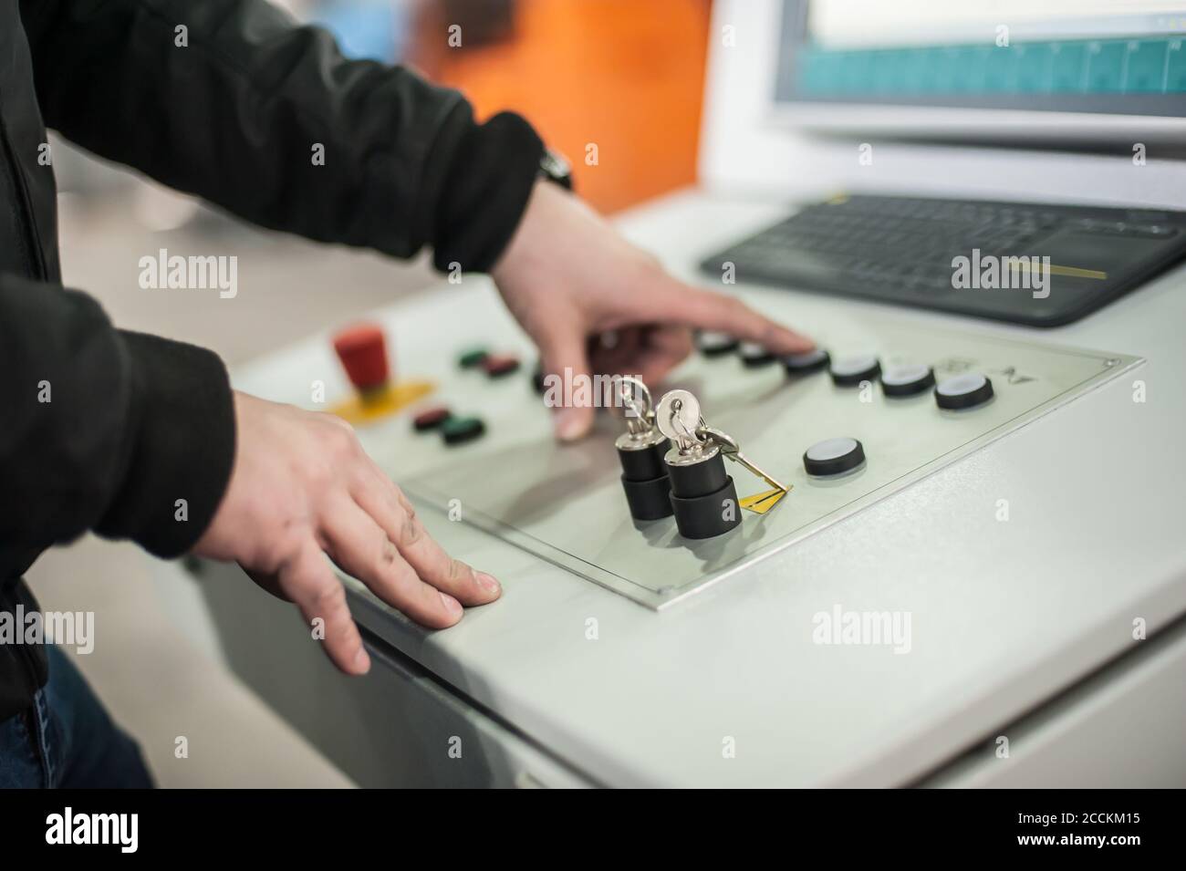 Industrial machinery mechanics and factory worker adjusts the control ...