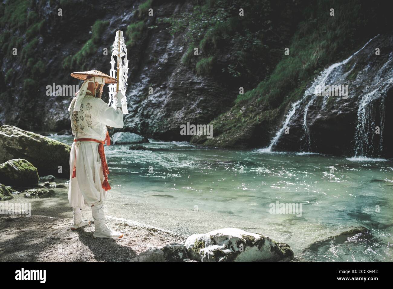 European yamabushi monk in traditional shugendo robe does water ...