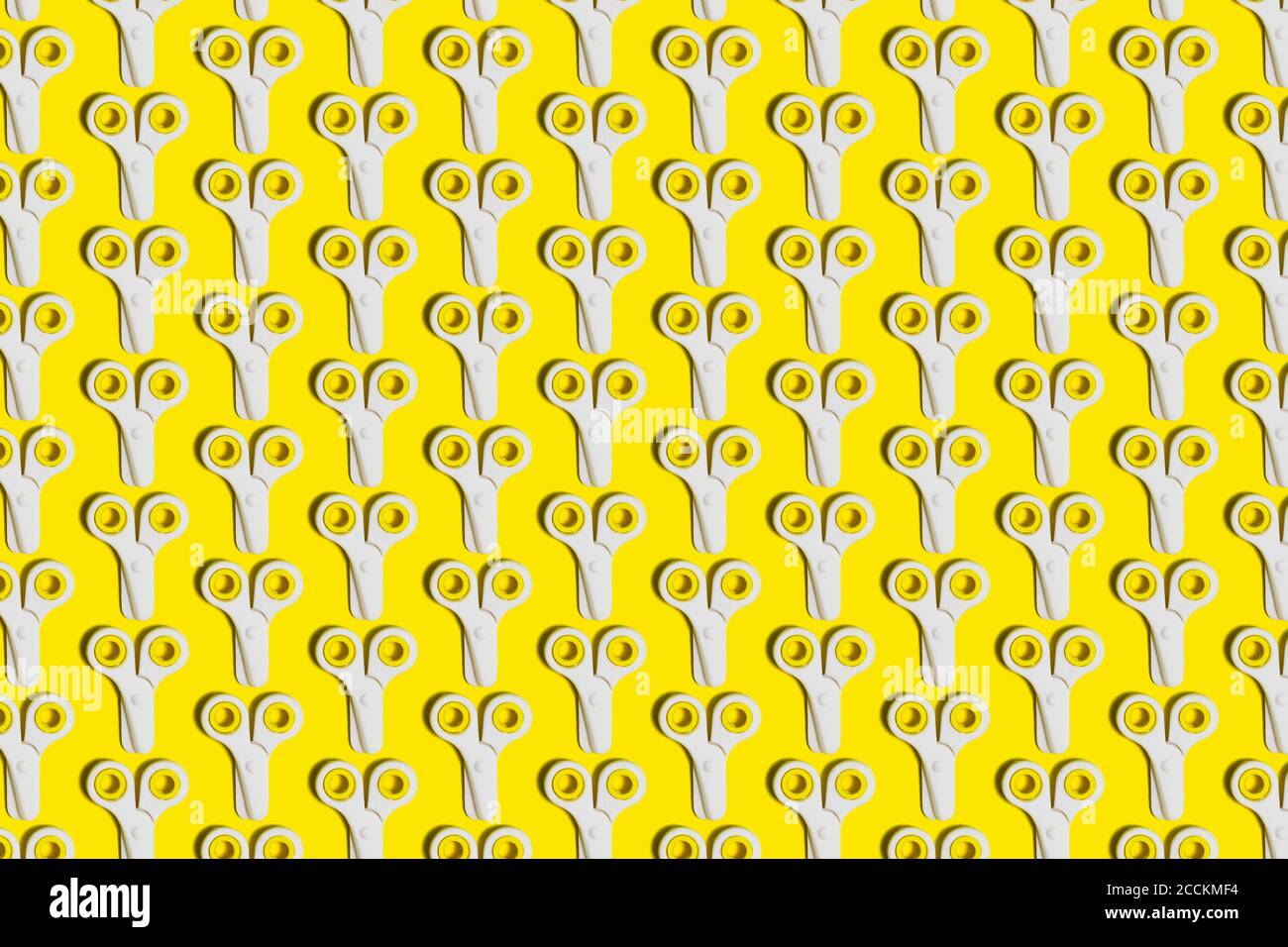 Pattern of rows of school scissors against yellow background Stock ...