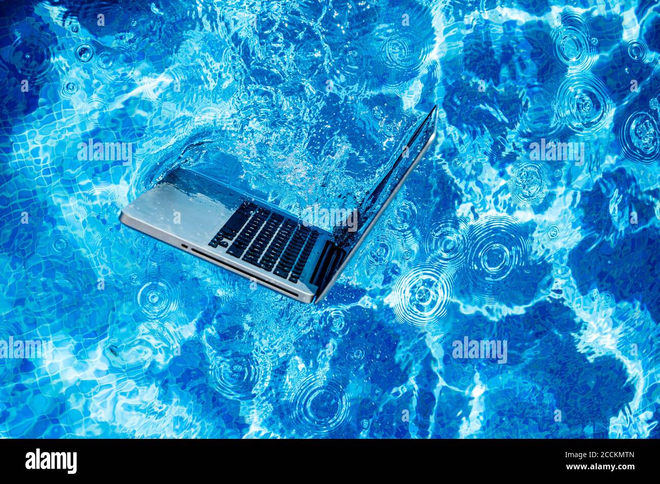 High angle view of laptop floating on swimming pool Stock Photo - Alamy