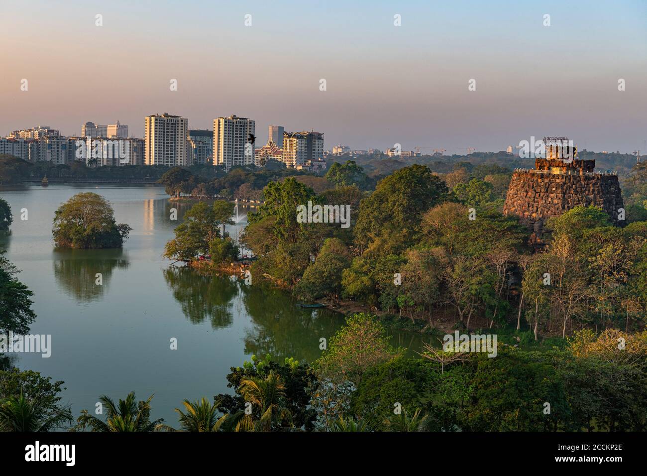 Myanmar, Yangon, Kandawgyi Lake with city skyline at sunset, aerial ...