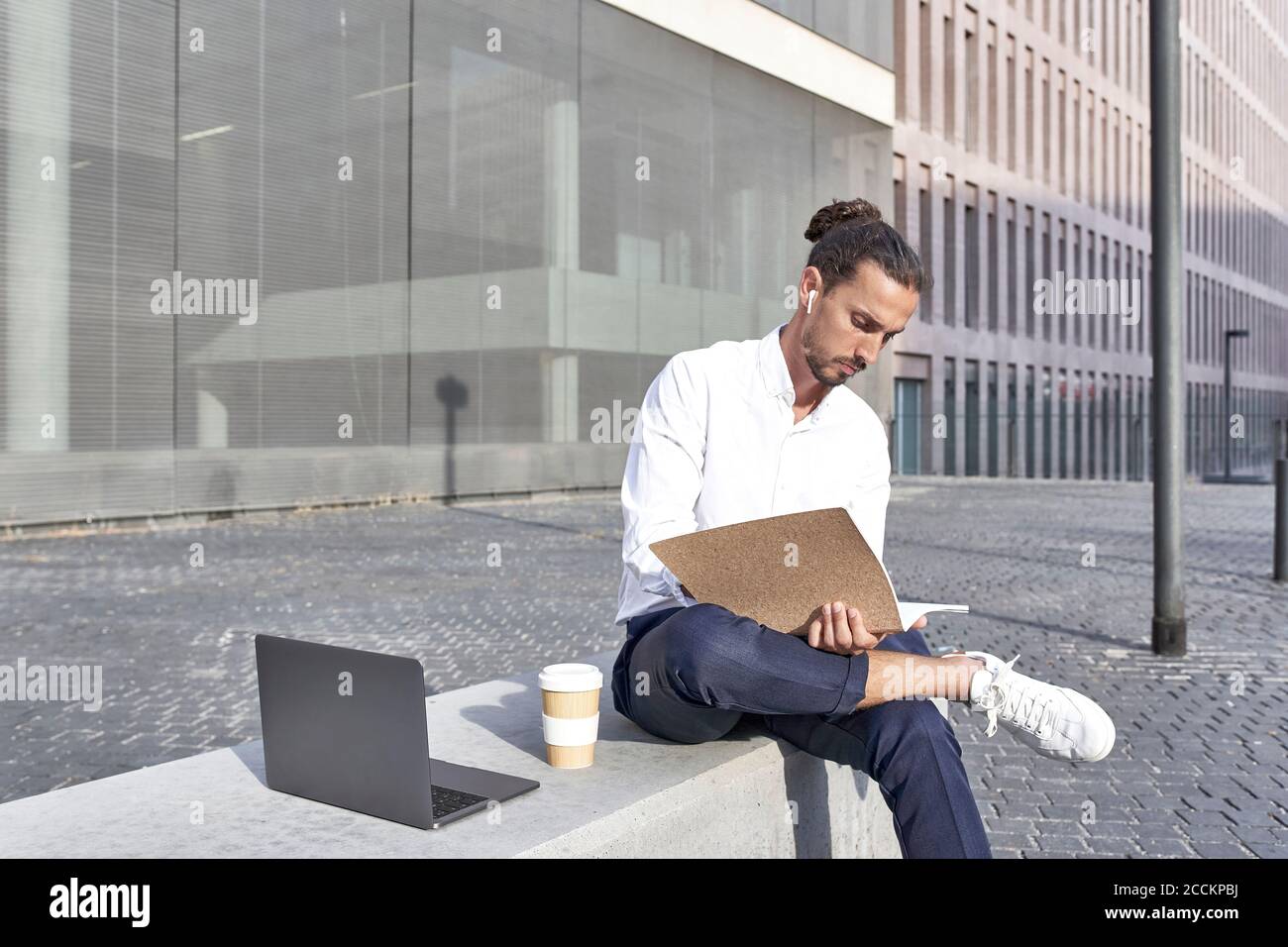 Businessman sitting on block outdoors hi-res stock photography and ...