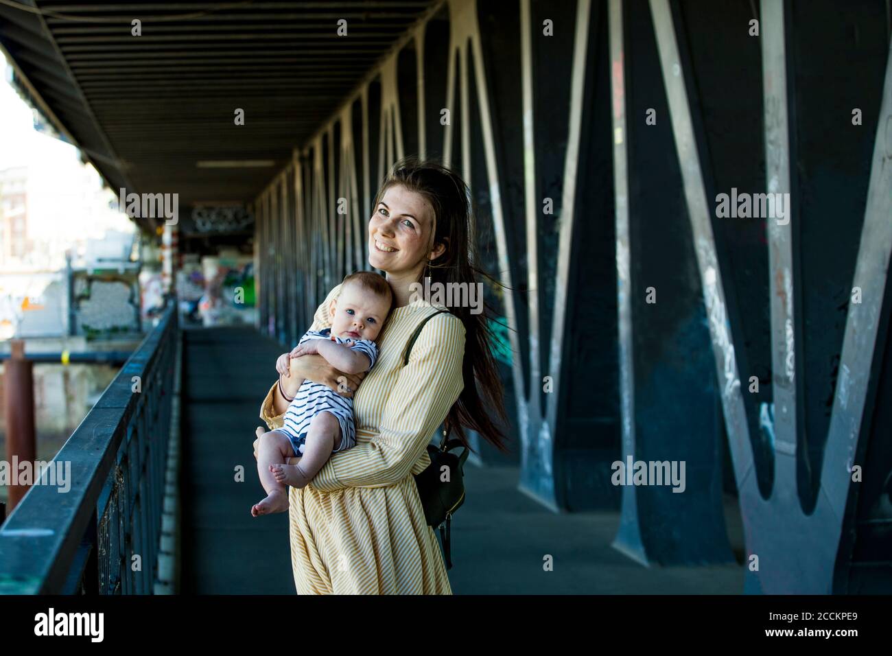 Mother with her baby boy on a bridge Stock Photo - Alamy