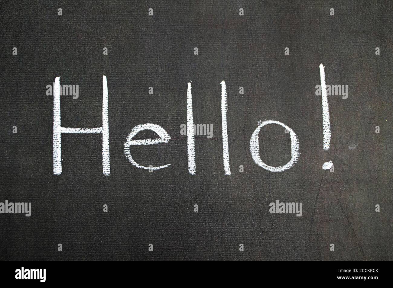 Greeting chalk hello white text on black background. Word welcome ...