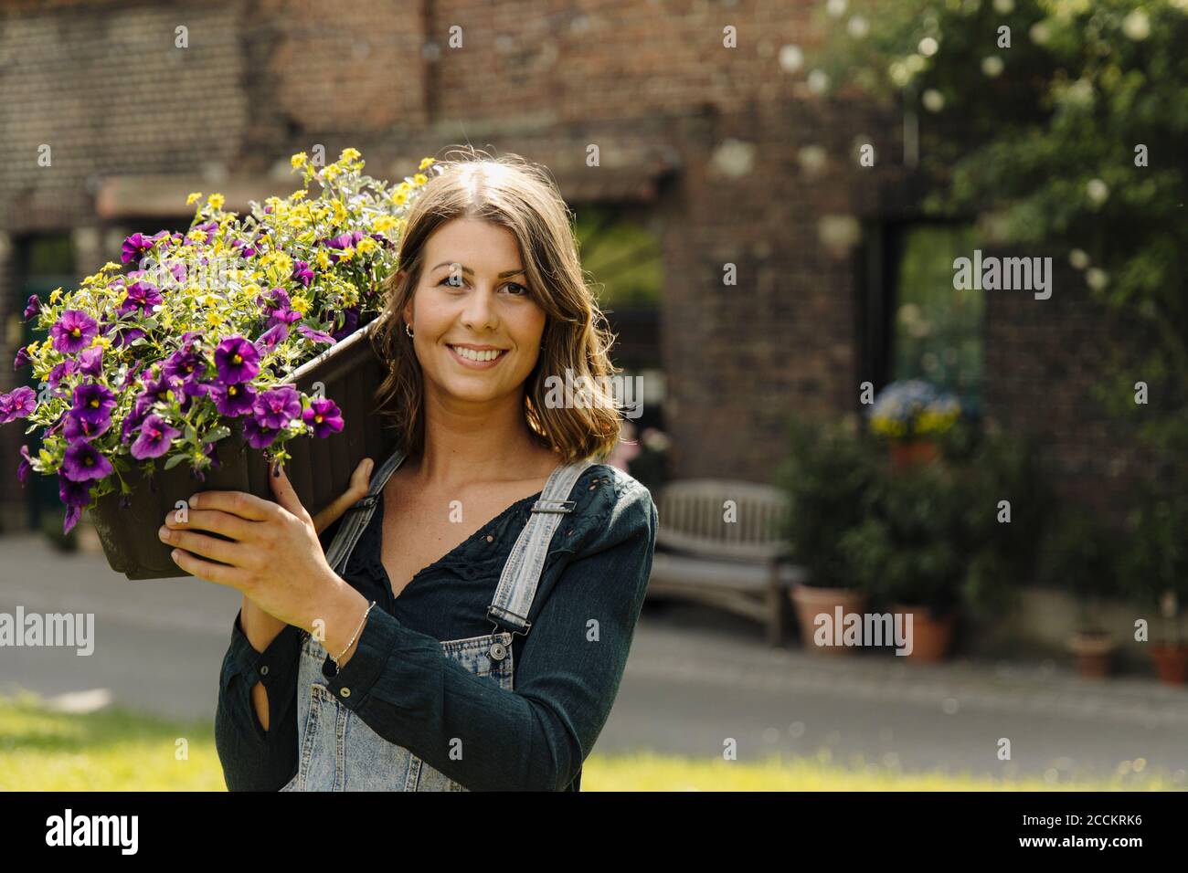 Woman carrying flower hi-res stock photography and images - Alamy