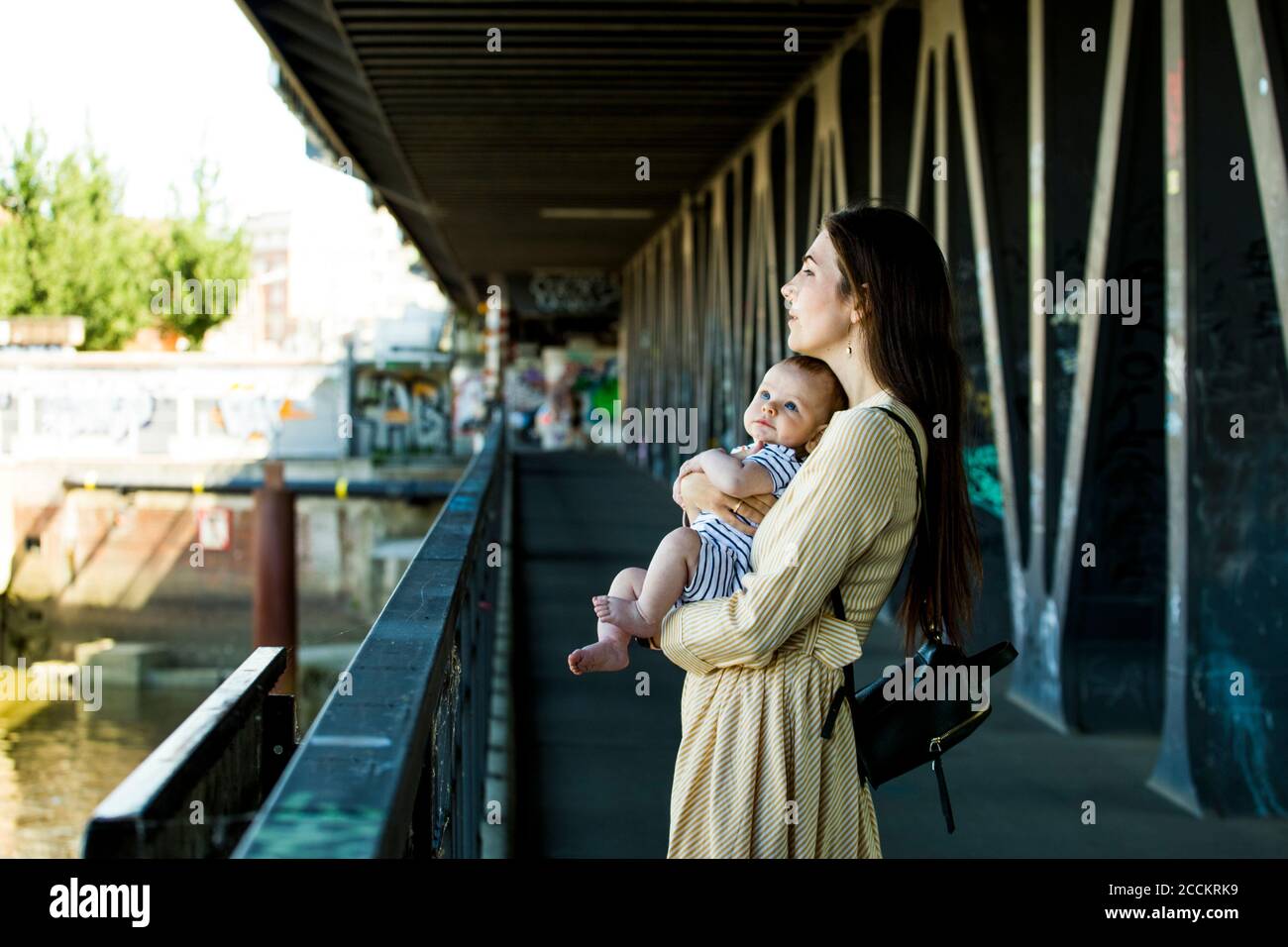 Mother with her baby baby on a bridge Stock Photo - Alamy