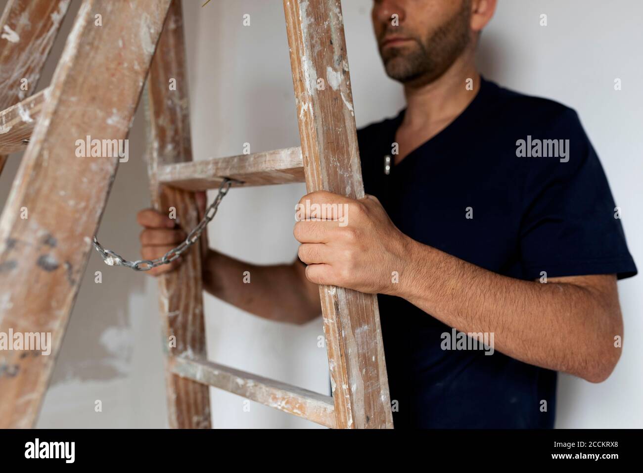Construction worker with step ladder Stock Photo - Alamy