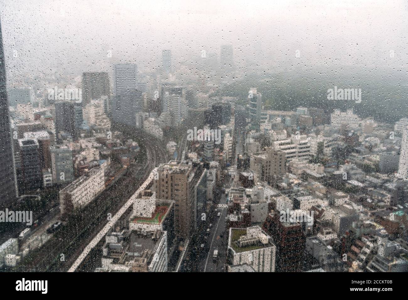 Japan, Tokyo, Downtown buildings on rainy day seen from window Stock ...