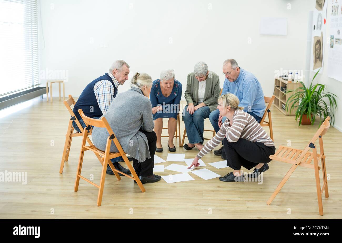 Group of seniors in retirement home evaluating result of group therapy ...