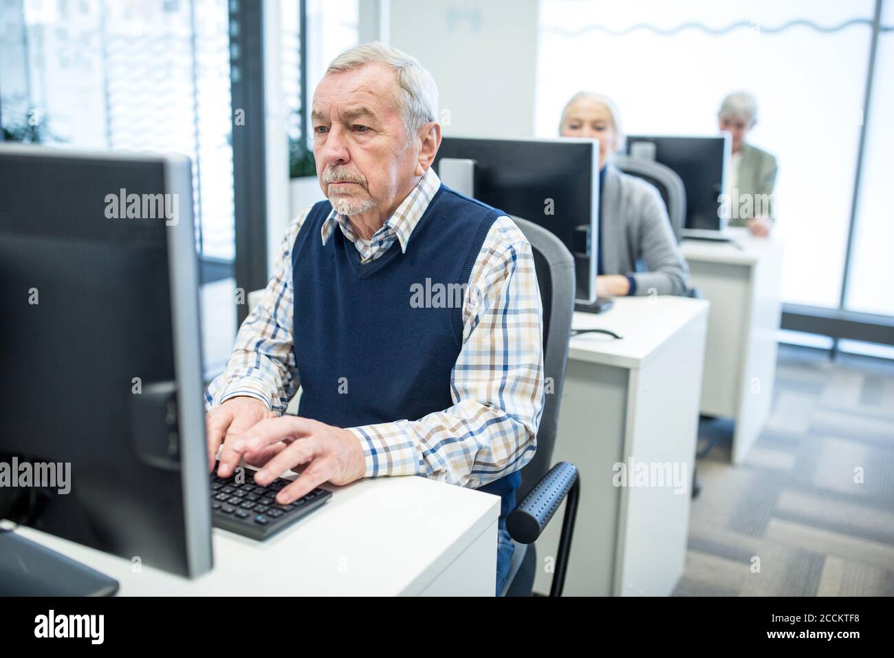 Active seniors attending computer course, working on PC Stock Photo - Alamy