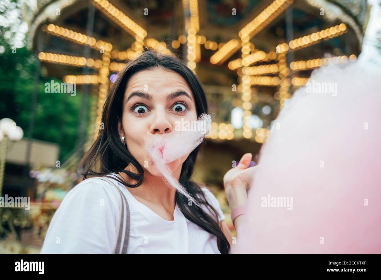 Young woman holding candyfloss in hi-res stock photography and images ...
