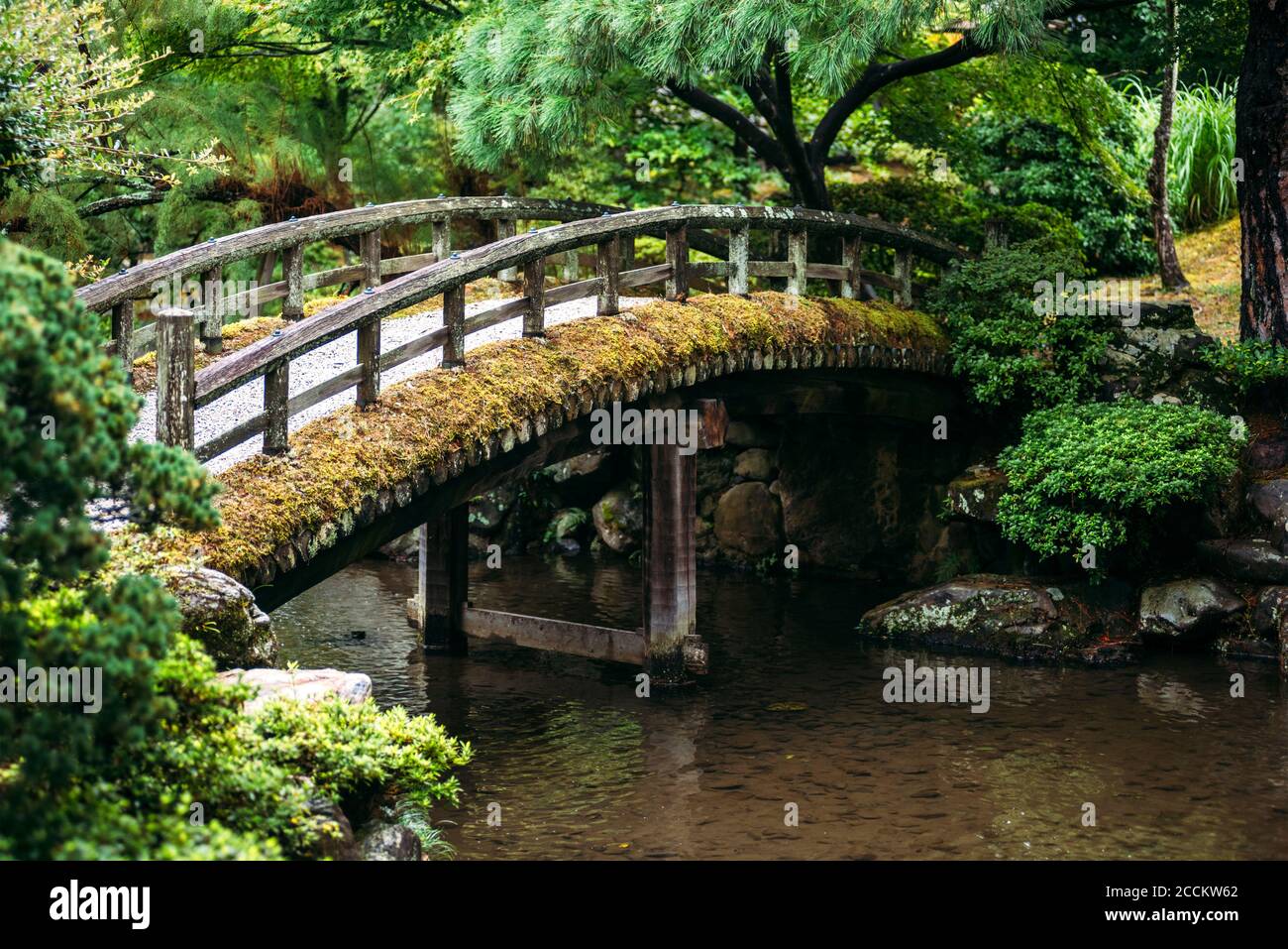 Japan, Kyoto, Footbridge over pond in Japanese garden Stock Photo - Alamy