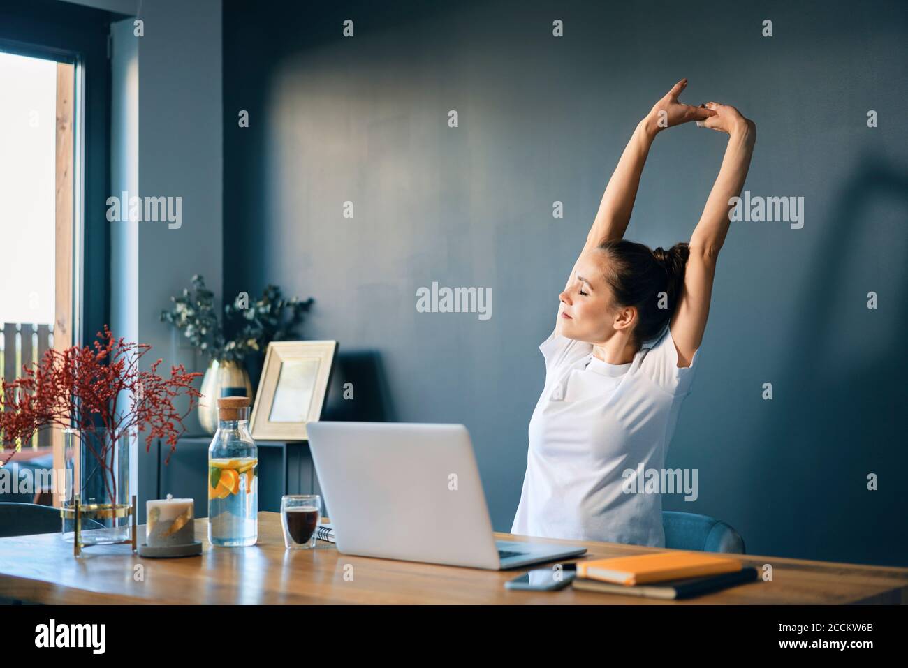 Tired business woman stretching hi-res stock photography and images - Alamy