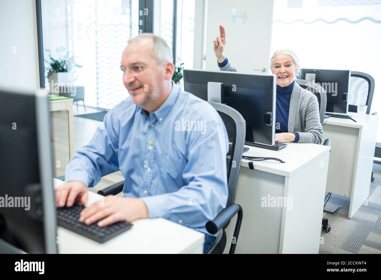Active seniors attending computer course, working on PC Stock Photo - Alamy