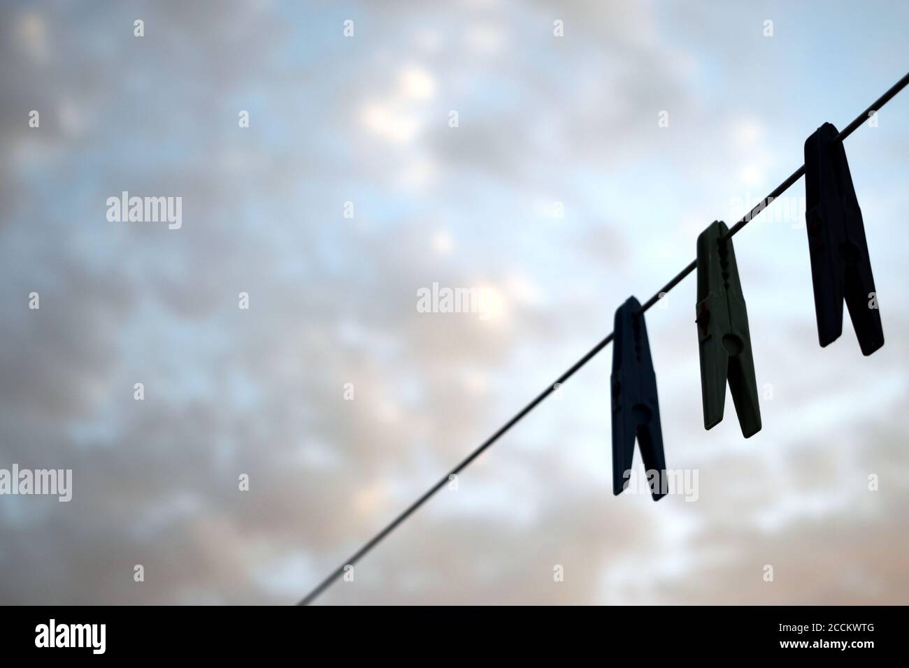 clothespins hanging on a wire with an equal distance between them ...