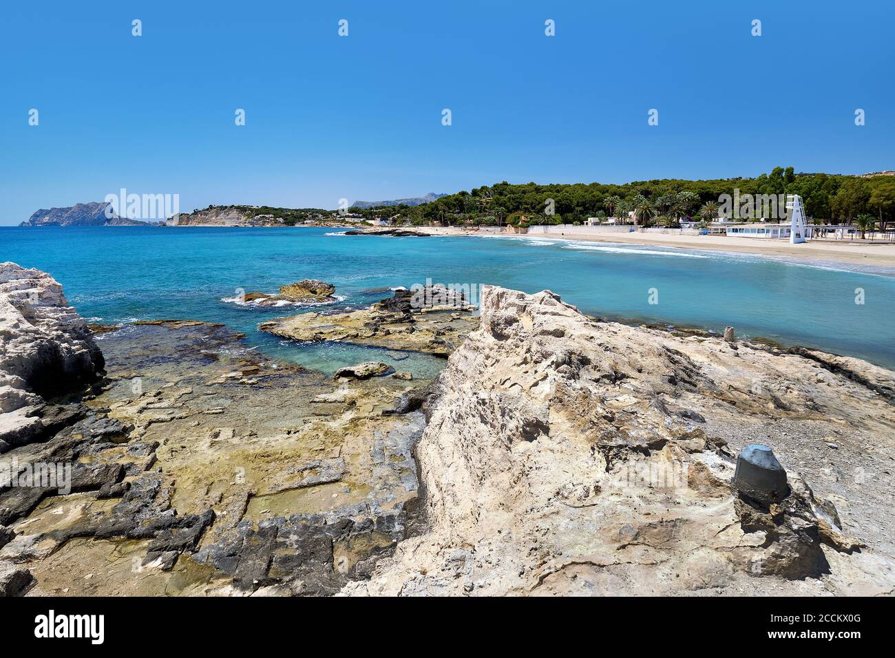 Beach of Moraira during sunny summer day, spanish coastal town. Spain ...