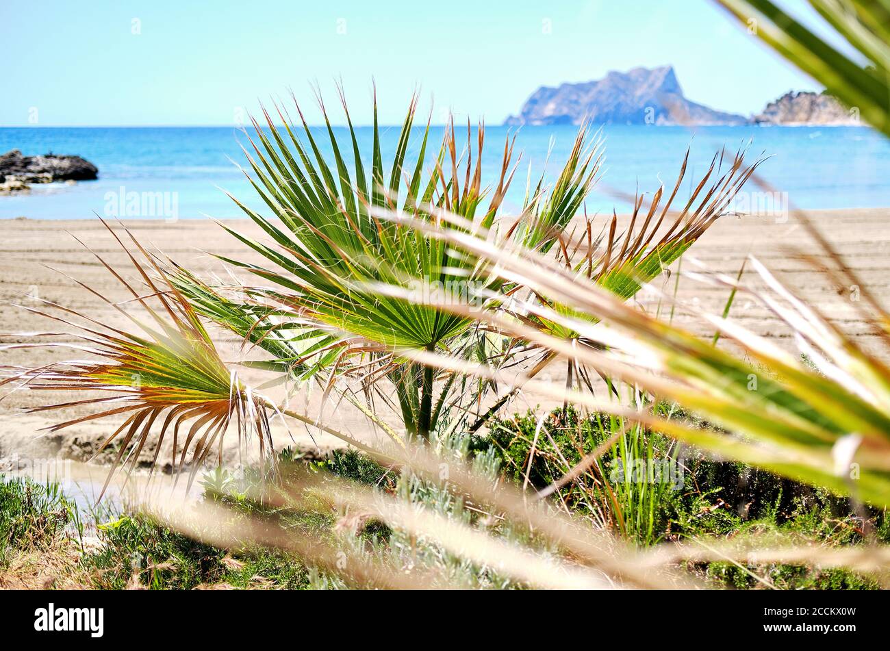 Beach of Moraira during sunny summer day, spanish coastal town. Spain ...