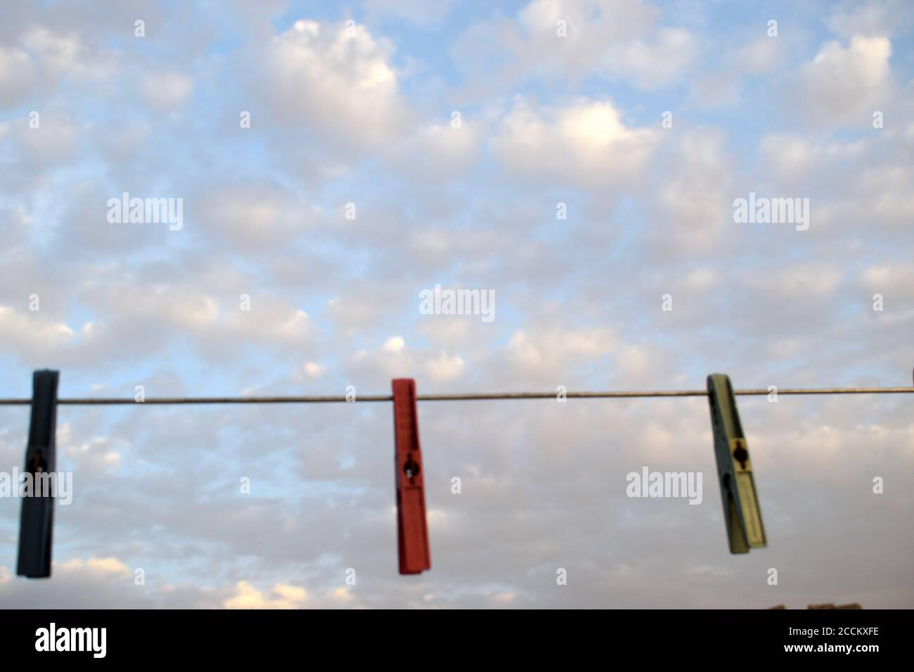 clothespins hanging on a wire with an equal distance between them ...