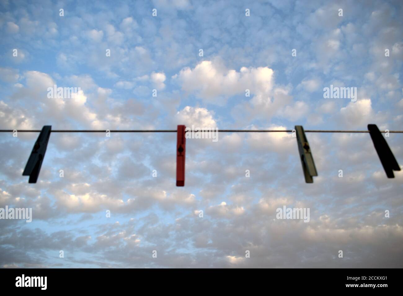 clothespins hanging on a wire with an equal distance between them ...