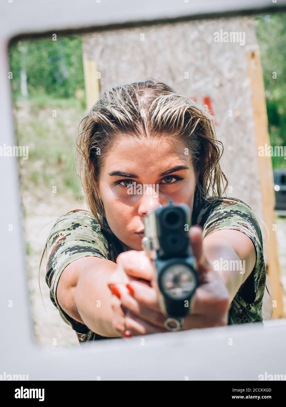 Close-up abstract view of attractive female army soldier have gun ...