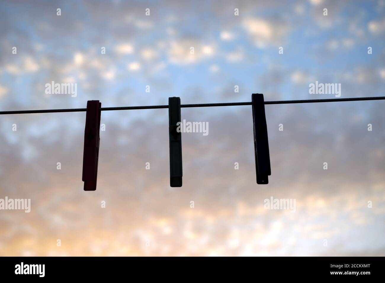clothespins hanging on a wire with an equal distance between them ...