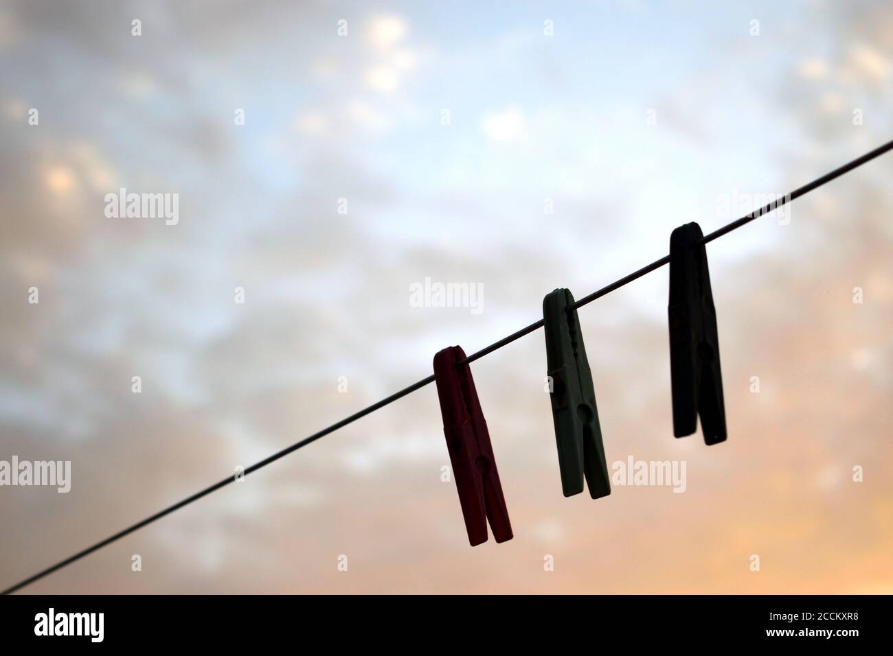 clothespins hanging on a wire with an equal distance between them ...
