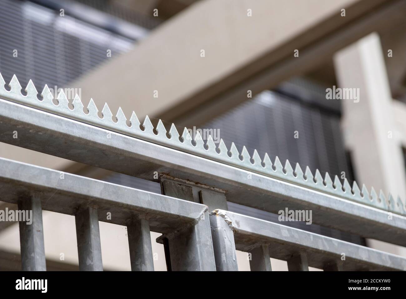 metal spikes on a strut above a gate, close-up Stock Photo - Alamy