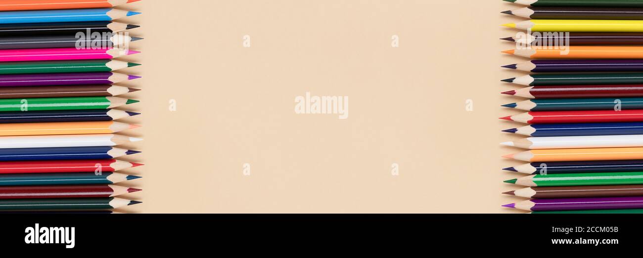Frame made of colorful pencils on a beige background. Banner with back ...