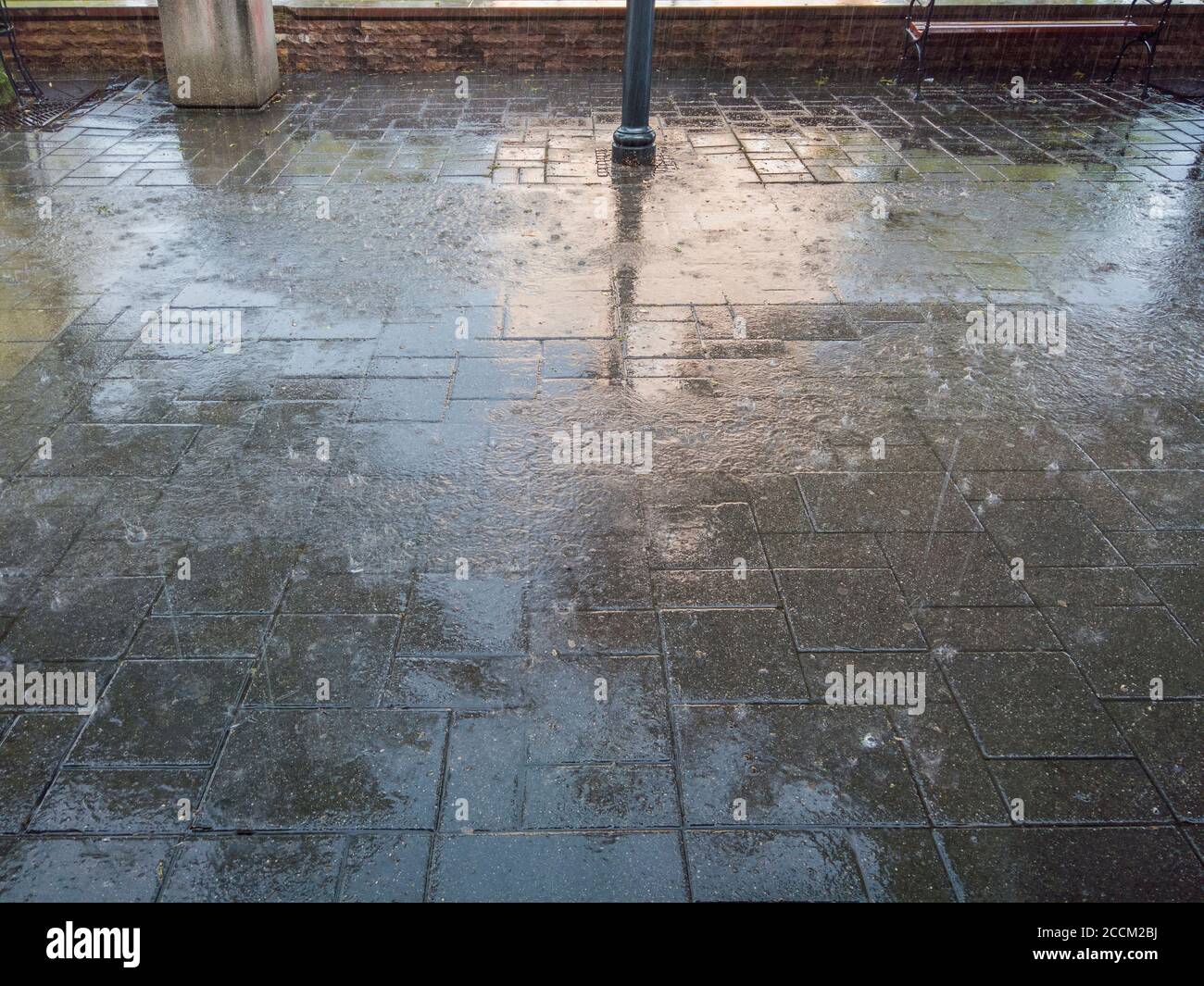 Heavy rain on a sidewalk Stock Photo - Alamy