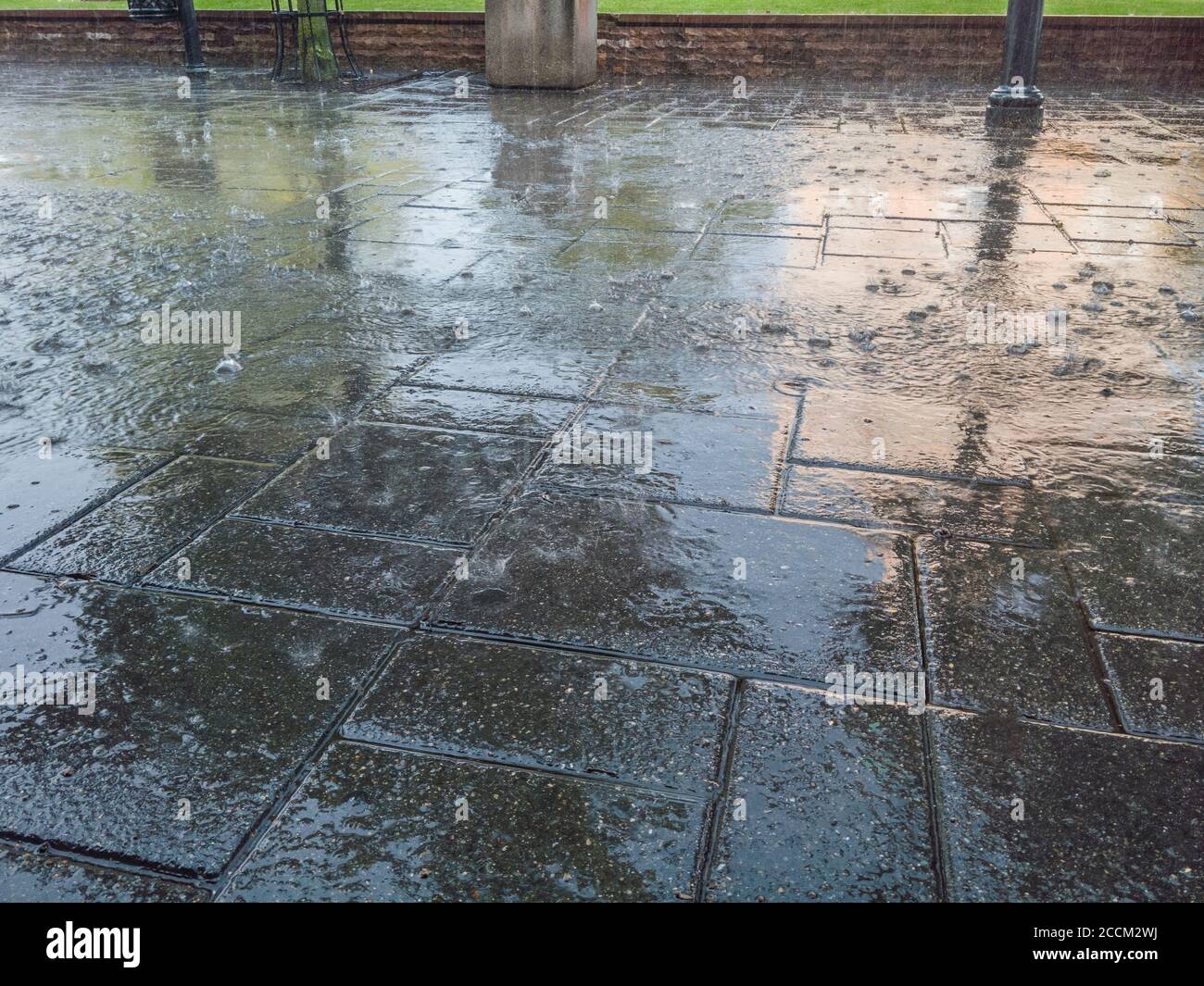 Heavy rain on a sidewalk Stock Photo - Alamy