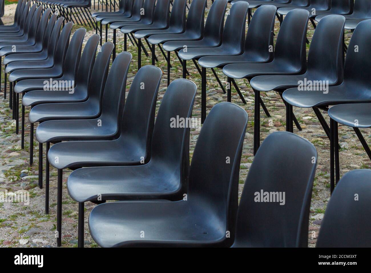 Black chairs in row outside Stock Photo - Alamy