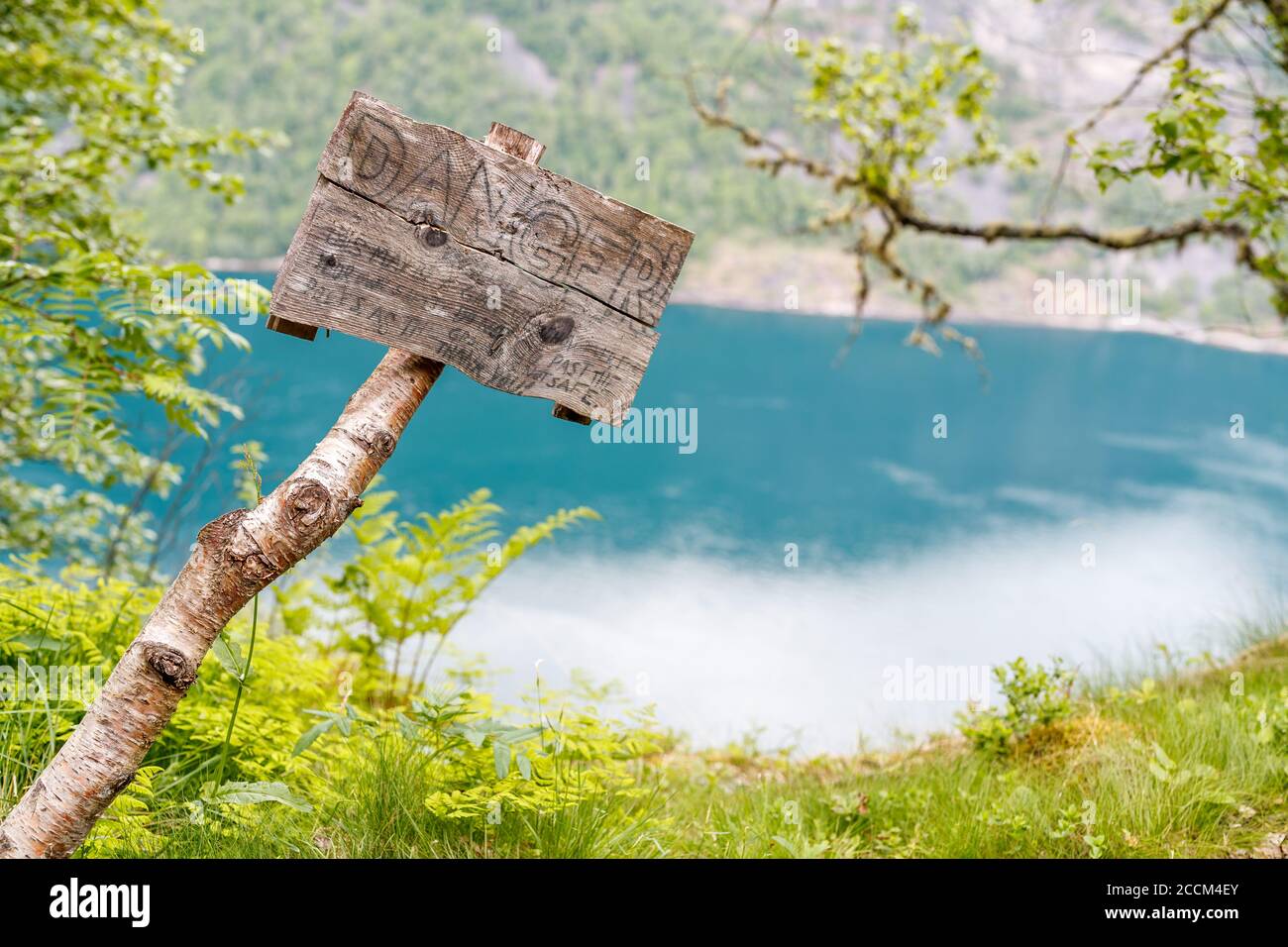 GEIRANGER, NORWAY - 2016 JUNE 12. Danger sign above Geiranger fjord on ...