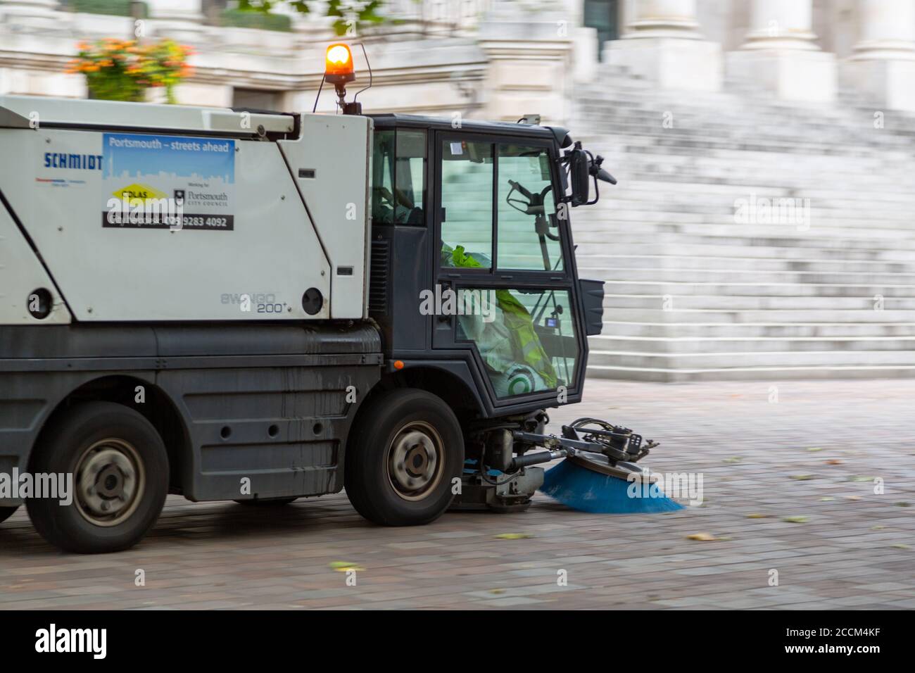 A road sweeping lorry sweeping the streets ensuring that they are ...