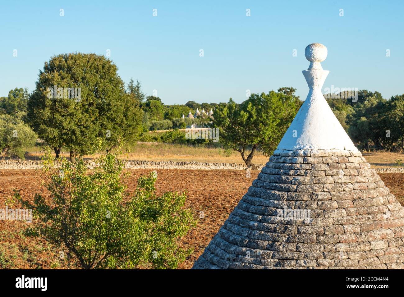 Group of Trulli, traditional old houses and old stone wall in Puglia ...
