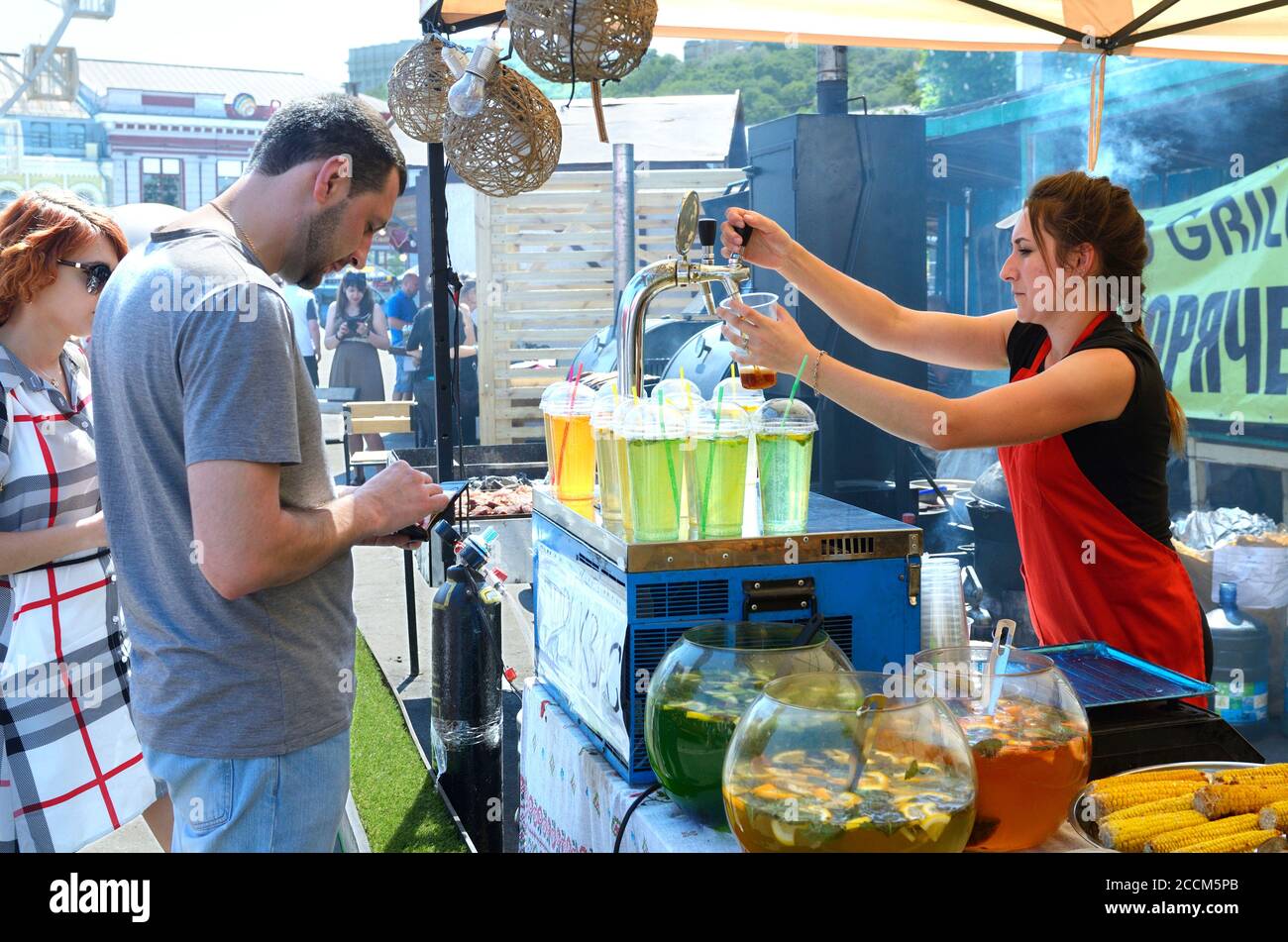 Street barmaid pouring beer in a glass for a customer. July 25, 2019 ...