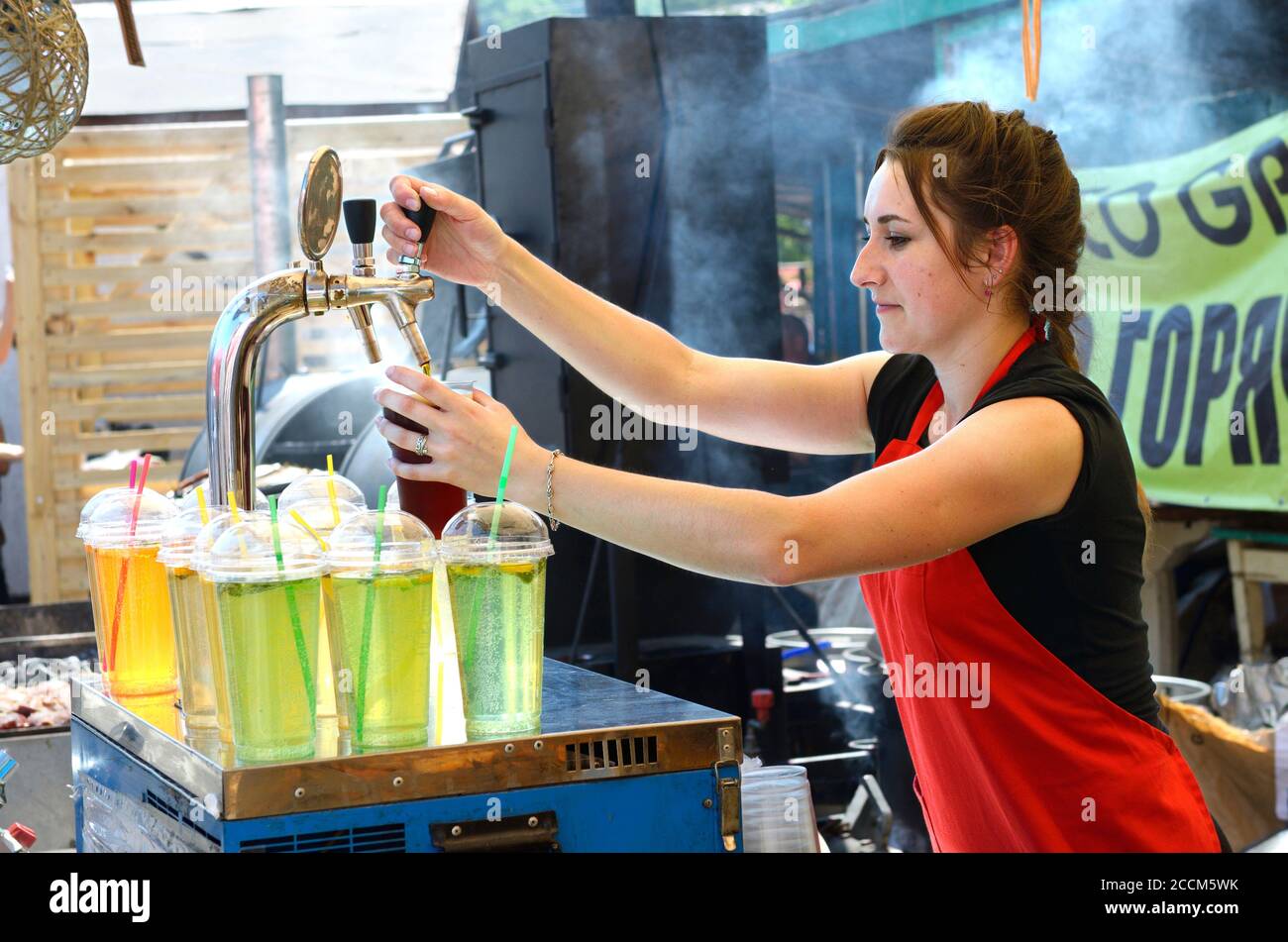 Street barmaid pouring beer in a glass for a customer. July 25, 2019 ...