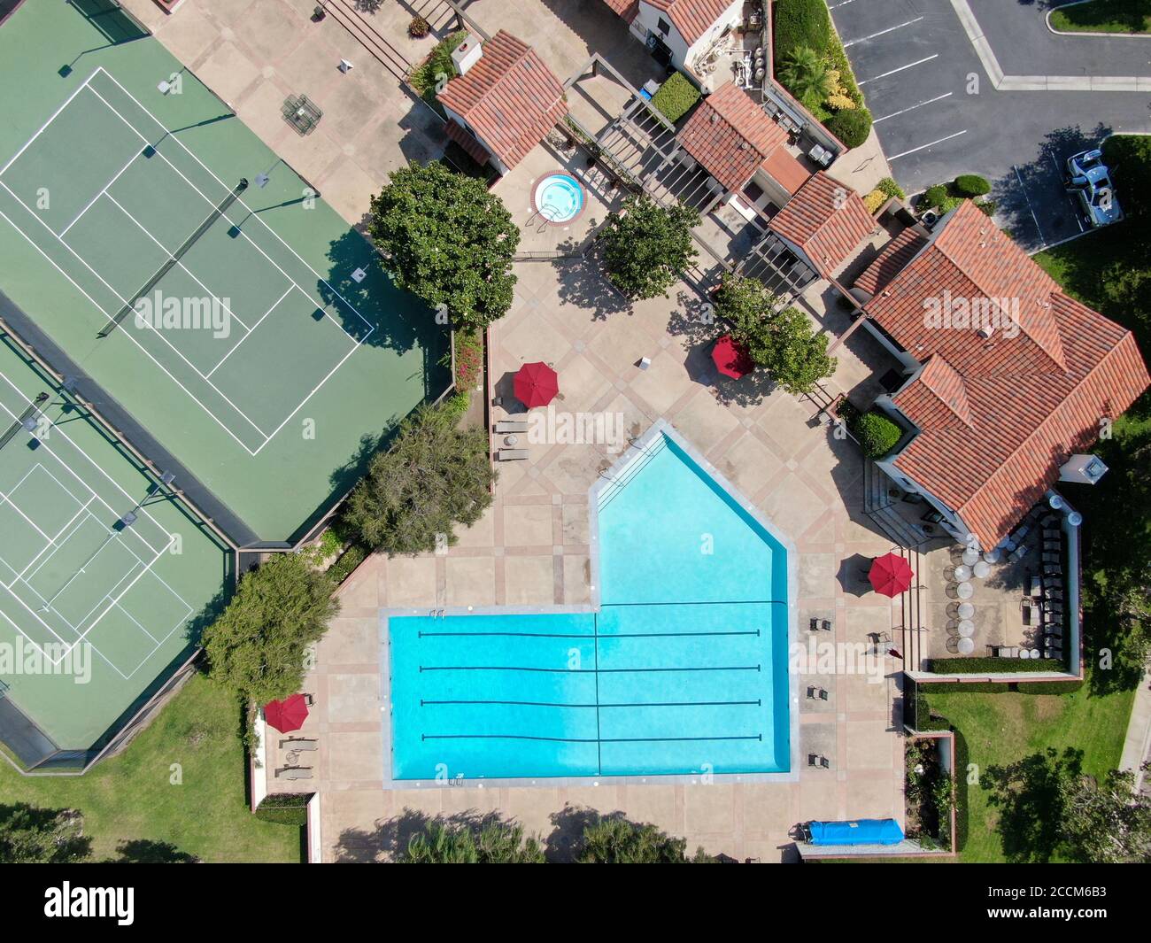 Aerial view swimming pool and tennis court in middle class neighborhood ...