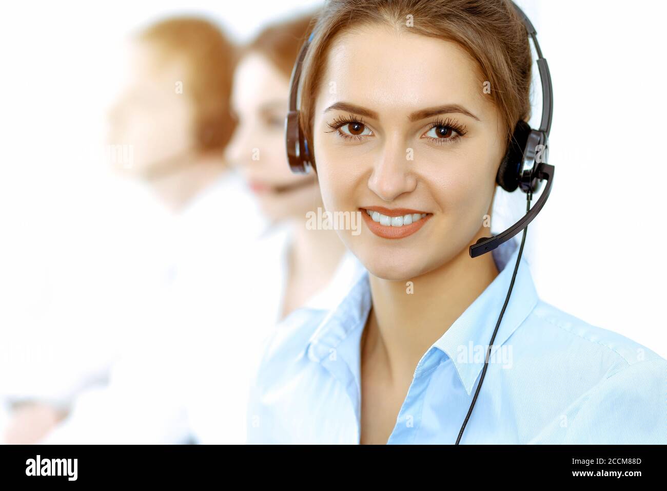 Call center. Focus on beautiful business woman in headset Stock Photo ...