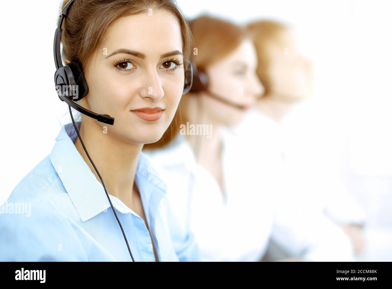 Call center. Focus on beautiful business woman in headset Stock Photo ...